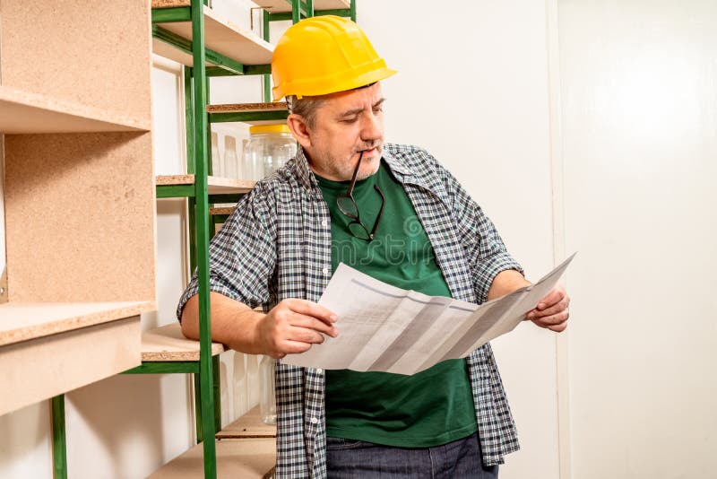 Male Worker Checking a List of Tasks or Products in a Warehouse or ...