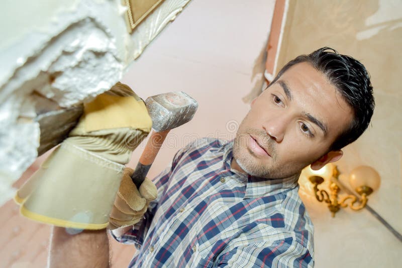 Male Worker Chiselling Off Plaster Stock Photo - Image of unshaven ...