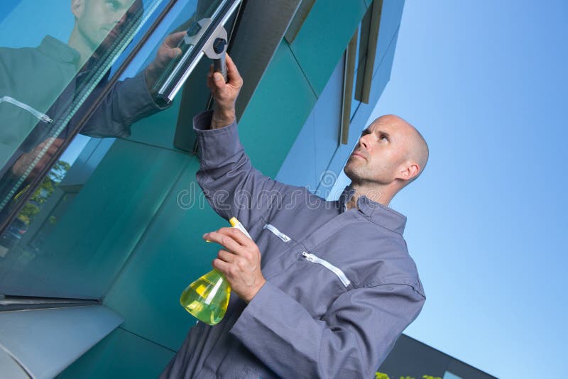 Male Worker Cleaning Glass with Rag Stock Photo - Image of service ...