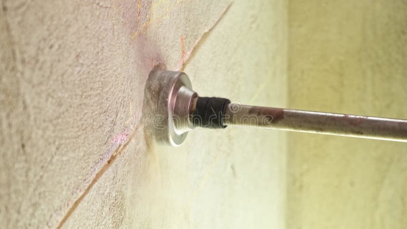 A Male Worker is Drilling a Socket in the Wall with a Drill Electrical ...