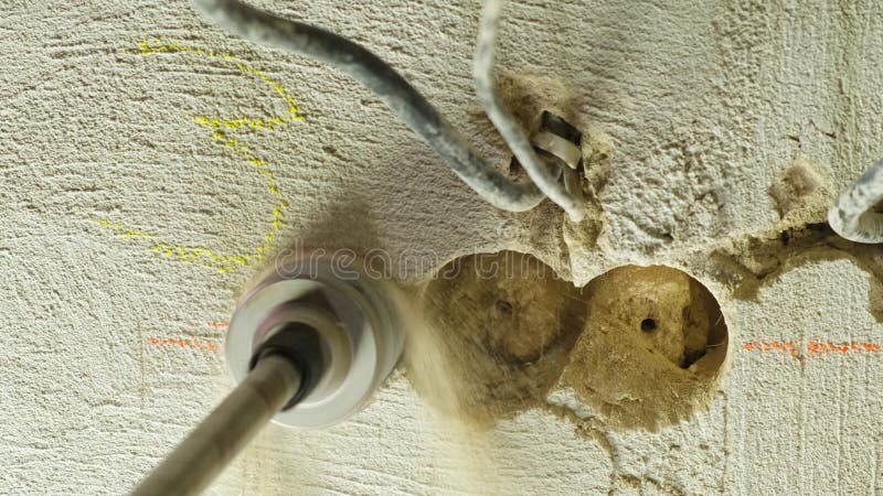 A Male Worker is Drilling a Socket in the Wall with a Drill Electrical ...