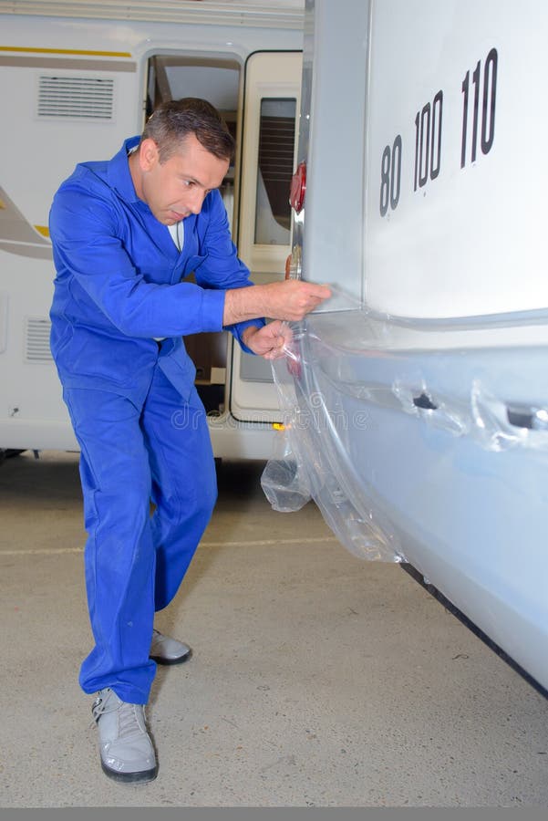Male worker fixing caravan stock image. Image of garage - 270839085