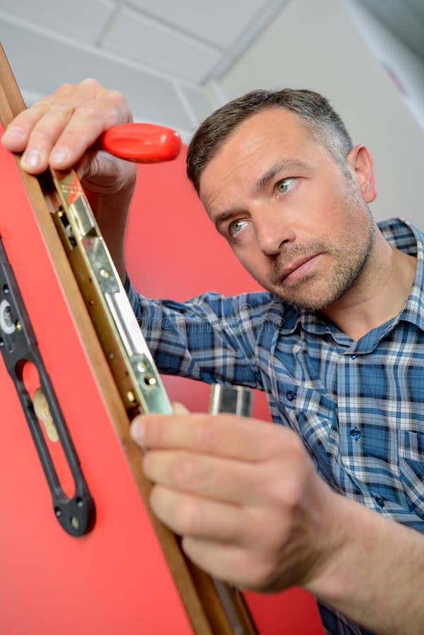 Male Worker Fixing Door Lock Stock Image - Image of renovate, home ...