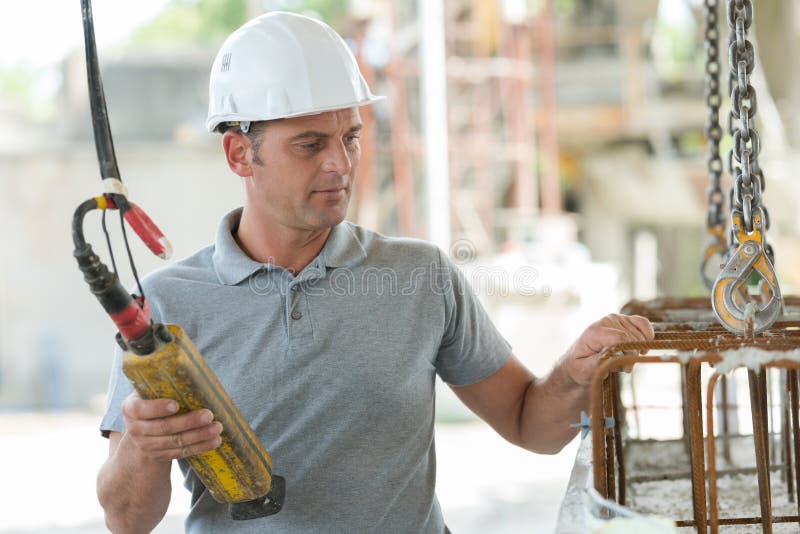 Male worker fixing hook stock image. Image of hardhat - 261512691