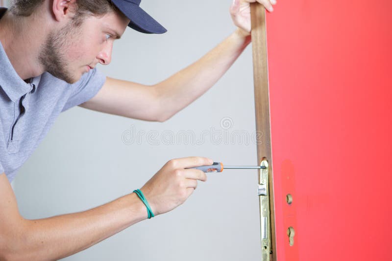 Male worker fixing lock stock photo. Image of office - 237933610