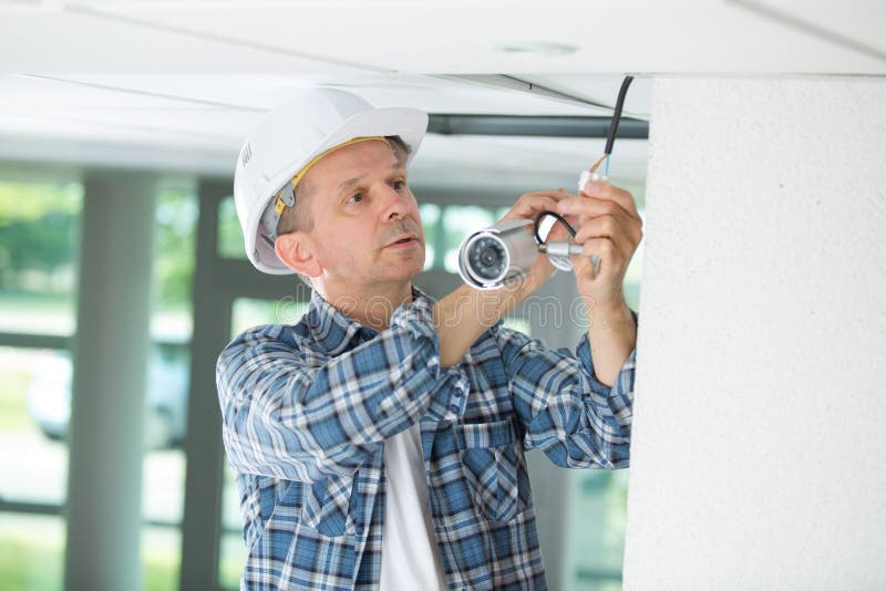 Male Worker Inspecting Security Camera Stock Image - Image of security ...