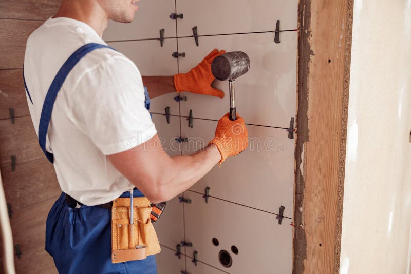Male Worker Installing Ceramic Wall Tile in House Stock Image - Image ...