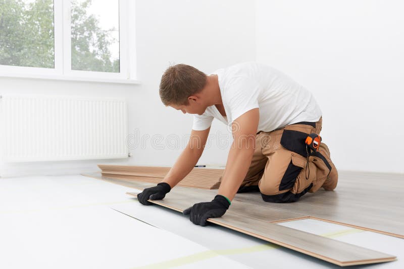 Male Worker Installing Laminate Flooring Stock Photo - Image of parquet ...