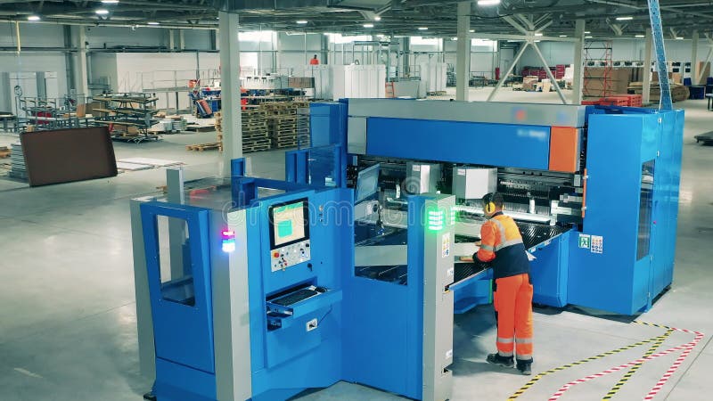 Male Worker is Loading Metal Plate into the Industrial Machine Stock ...