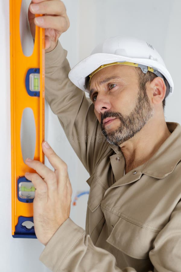 Male worker man with level stock image. Image of industrial - 285207663