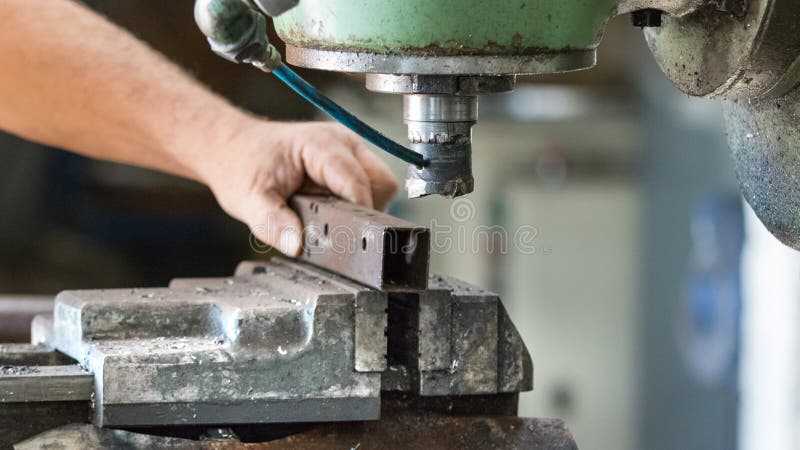 A Worker Operating a Milling Cutter Drill Machine Inside an Aluminiun ...