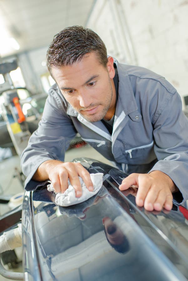Male worker polishing car stock photo. Image of care - 294501110
