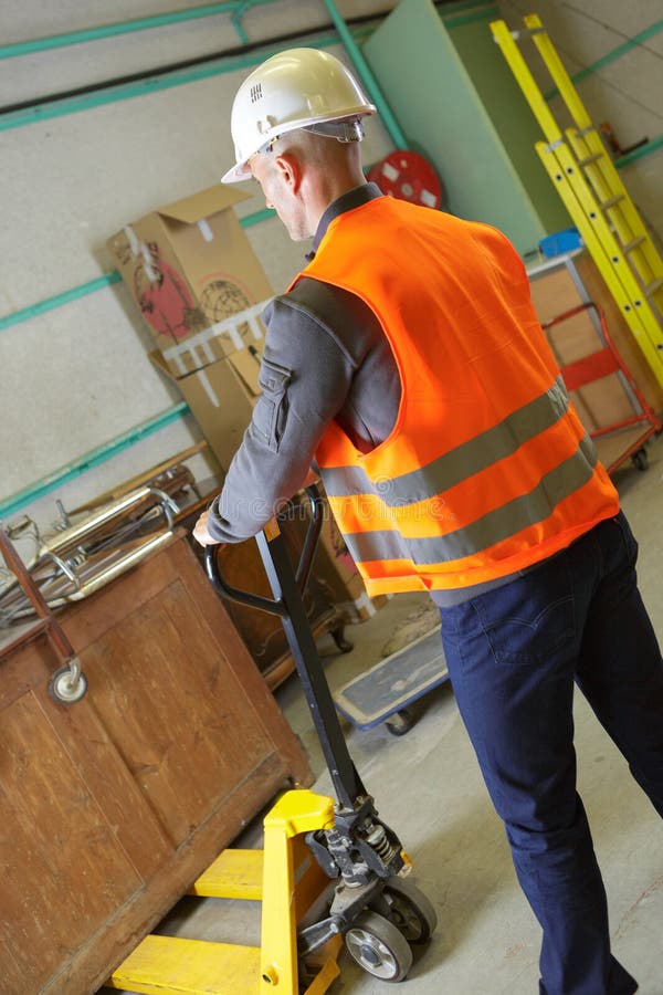 Male Worker Pulling Trolley Stock Photo - Image of pulling, industry ...