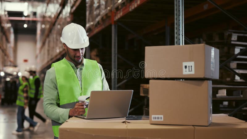 Male Worker Scanning Box with Barcode Scanner Using Laptop at Warehouse ...
