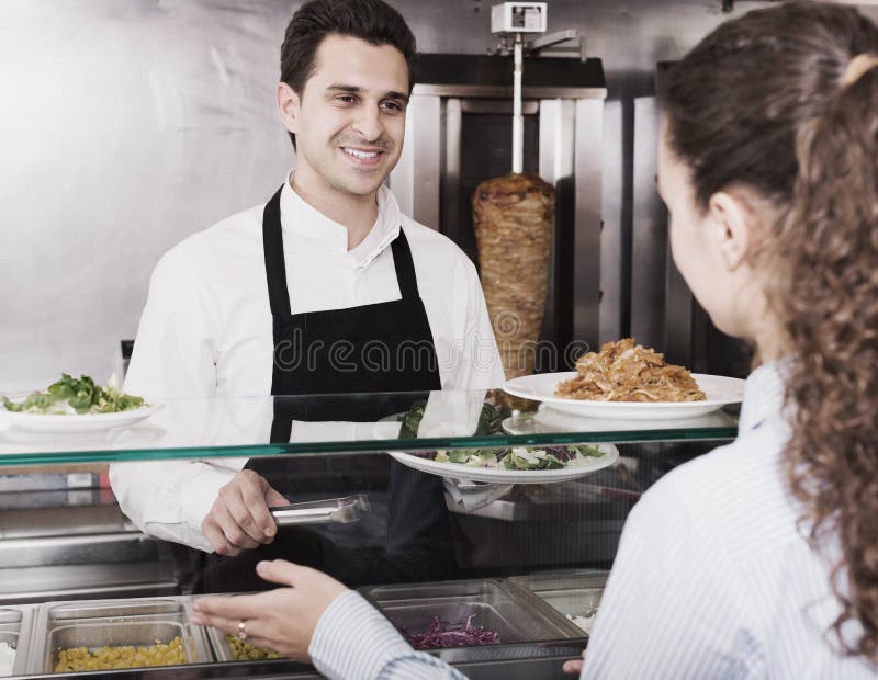 Male Worker Serving Customer Stock Image - Image of assistant, female ...