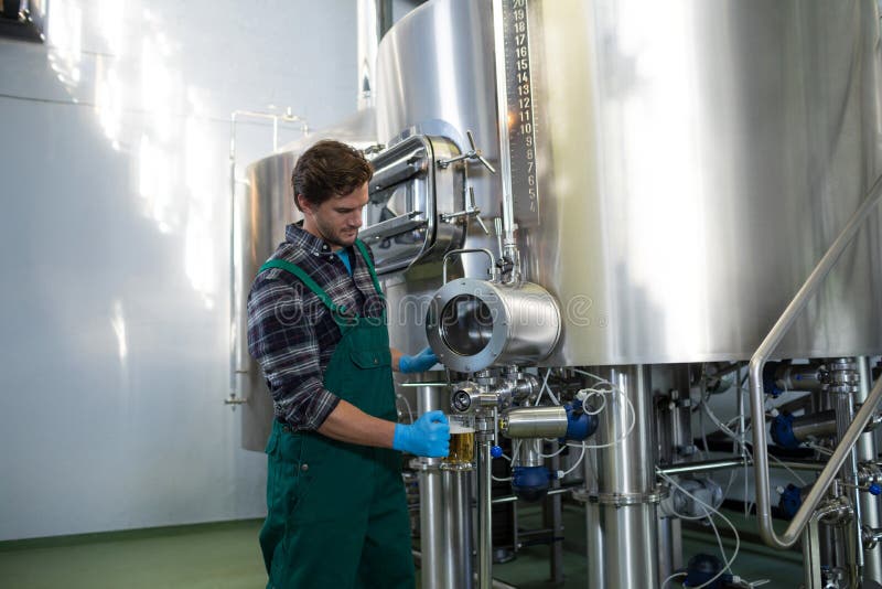Male Worker Taking Beer from Storage Tank at Factory Stock Photo ...