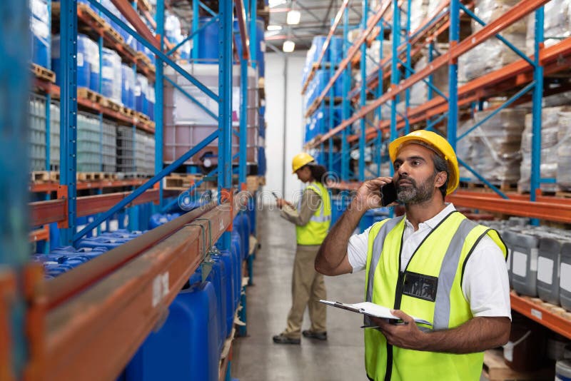 Male Worker Talking on Mobile Phone in Warehouse Stock Image - Image of ...