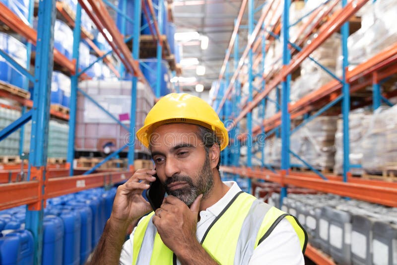 Male Worker Talking on Mobile Phone in Warehouse Stock Image - Image of ...