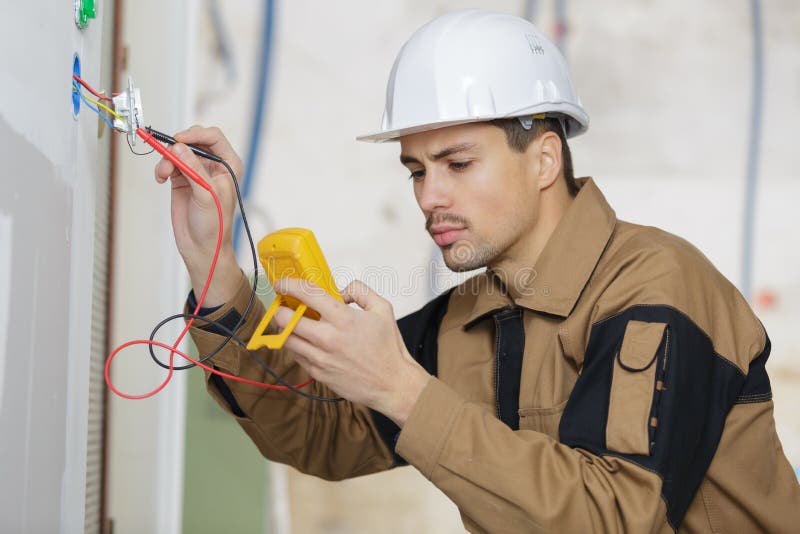 Male Worker Testing Wall Socket with Multimeter Stock Photo - Image of ...