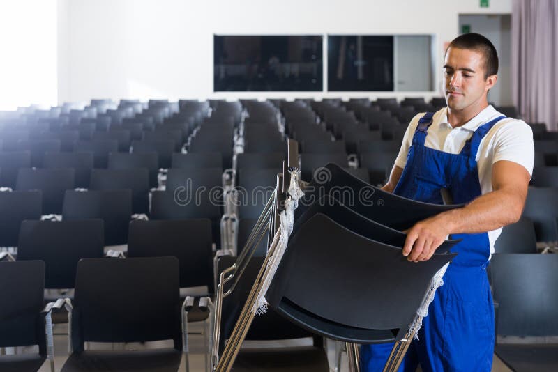Worker Carrying Chairs in Empty Room Stock Image - Image of audience ...