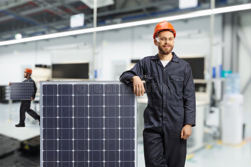 Male Worker in a Uniform Leaning on a Solar Collector in a Factory ...