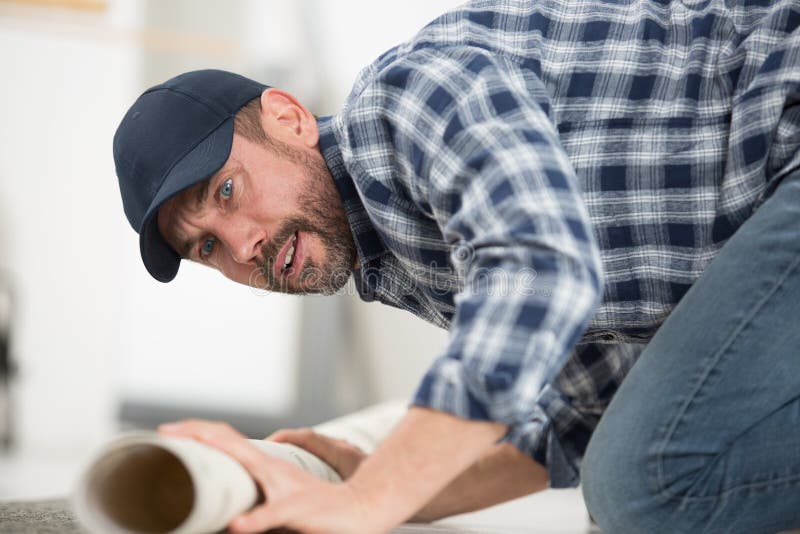 Male Worker Unrolling Carpet on Floor at Home Stock Image - Image of ...