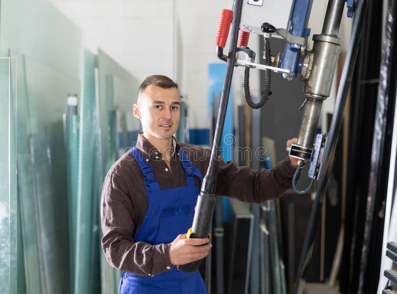 Male Worker Using Control Panel and Lifting Mechanism Controls Movement ...