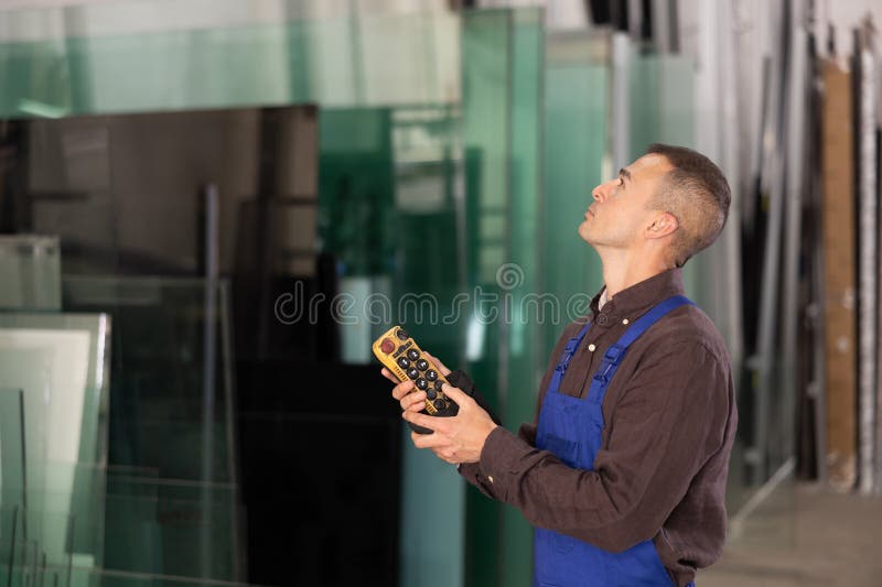 Male Worker Using Control Panel and Lifting Mechanism Controls Movement ...