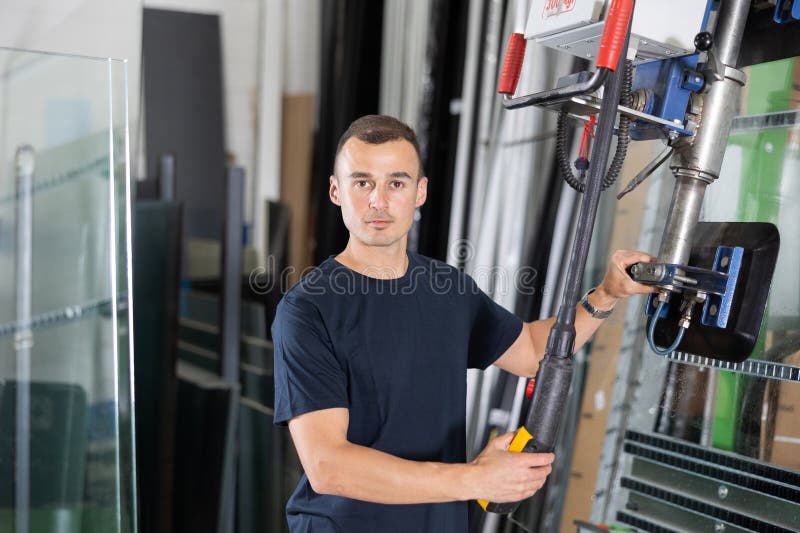 Male Worker Using Control Panel and Lifting Mechanism Controls Movement ...