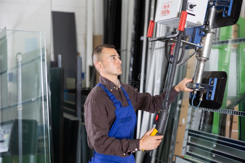 Male Worker Using Control Panel and Lifting Mechanism Controls Movement ...