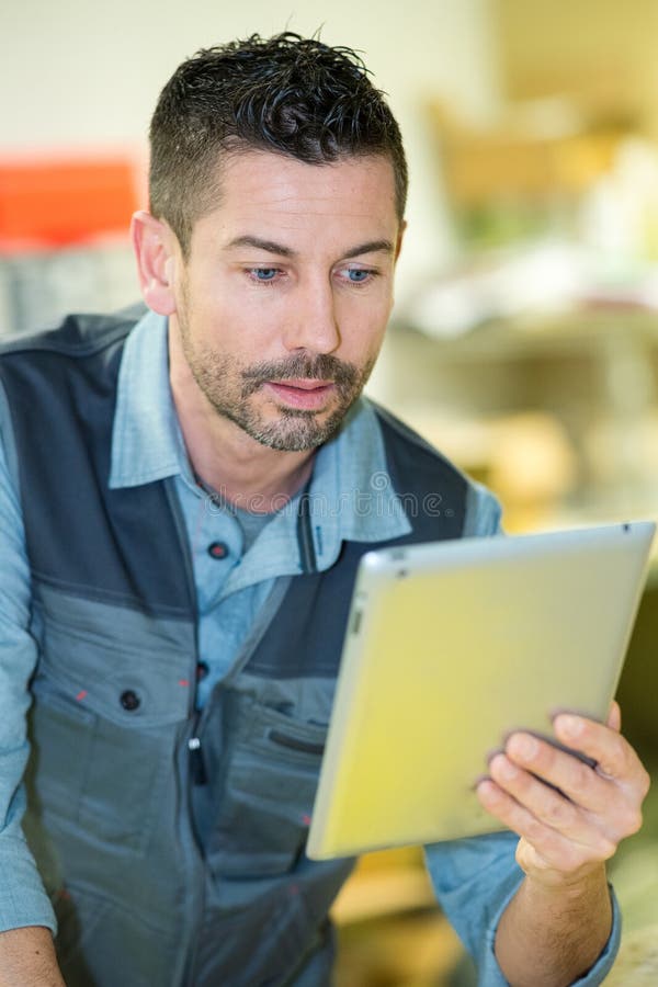 Male Worker Using Digital Tablet Stock Photo - Image of goods, notes ...