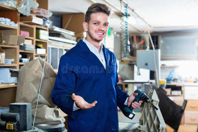 Male Worker Using Drill for Work at Workshop Stock Image - Image of ...