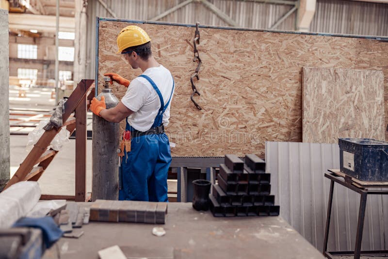 Male Worker Using Gas Cylinder in Workshop Stock Image - Image of young ...