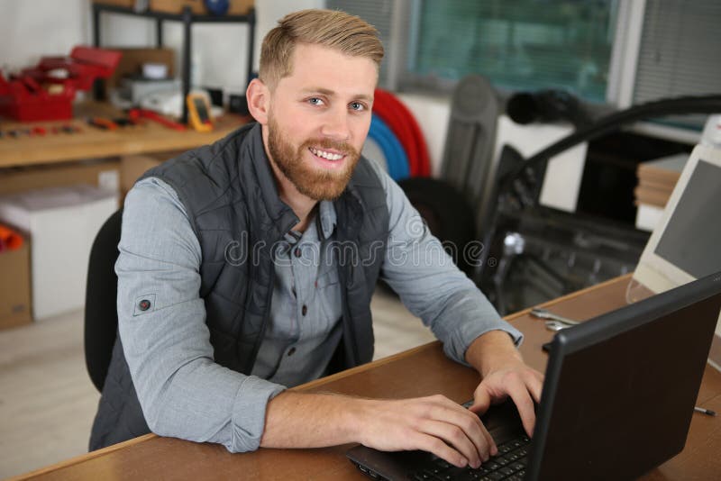 Male Worker Using Laptop in Workshop Stock Image - Image of technology ...