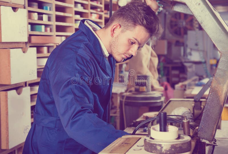 Male Worker Using Machine for Trimming at Workshop Stock Image - Image ...