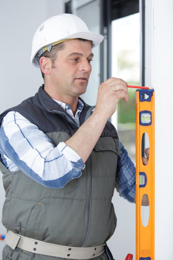 Male Worker Using Spirit Level Stock Photo - Image of tradesperson ...