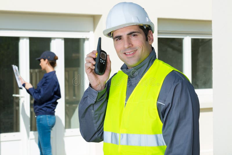 Male Worker Using Walkie-talkie Stock Image - Image of talkie, daytime ...
