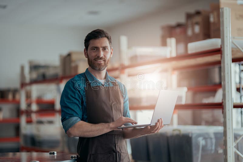Male Worker Working Laptop on Background of Warehouse Stock Image ...