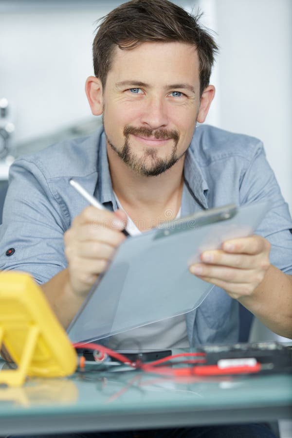 Male Worker Writing on Clipboard Stock Image - Image of check, assembly ...