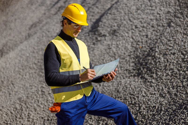 Male Worker Writing Documents Outdoors at Cement Factory Stock Photo ...