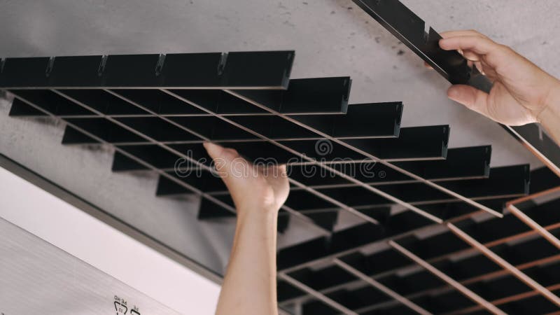 Male Workers Installing Panels for Open Cell Ceiling Stock Footage ...