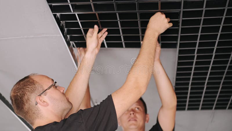 Male Workers Installing Panels for Open Cell Ceiling Stock Video ...