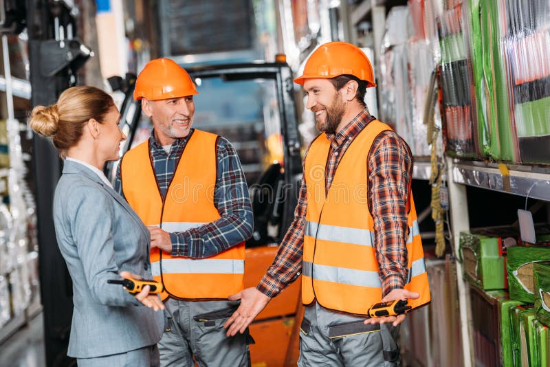Male Workers in Safety Vests and Helmets Talking with Inspector Stock ...