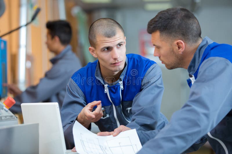 Male Workers Talking about Plan on Blueprint Stock Photo - Image of ...