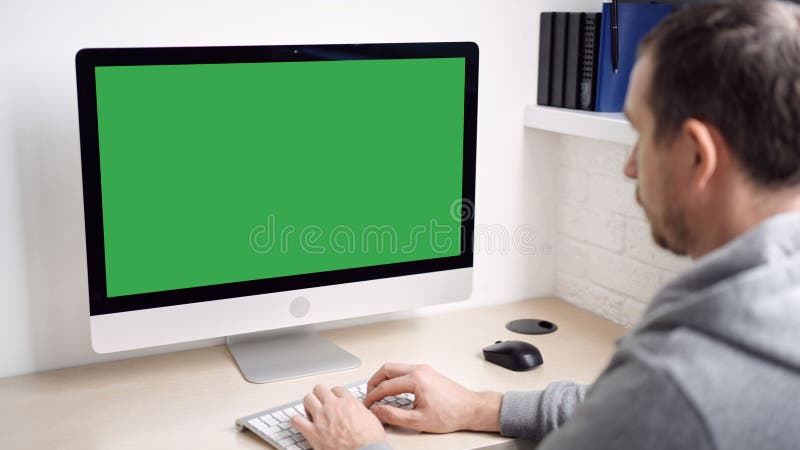 Male Working with a Computer Display with Greenscreen Stock Photo ...