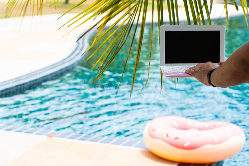 Male Working on His Laptop, Sitting by the Pool. Male Hands on the ...