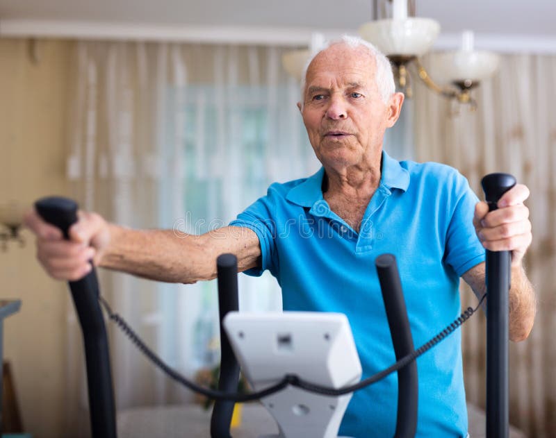 Male is Working Out on Elliptical Machine for Elder Healthy Concept ...