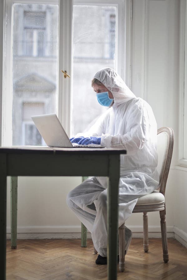 Male Works on a Computer Protected by Medical Suit and Mask Stock Photo ...