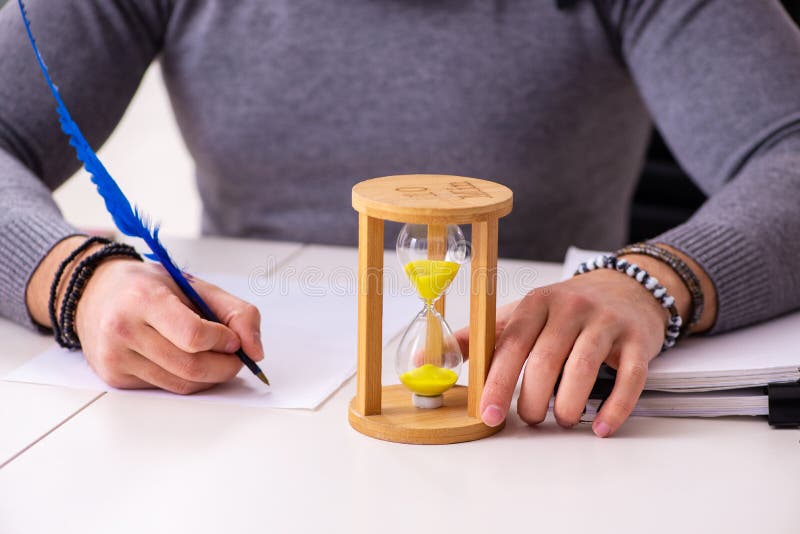Young Male Writer in Time Management Concept Stock Image - Image of ...