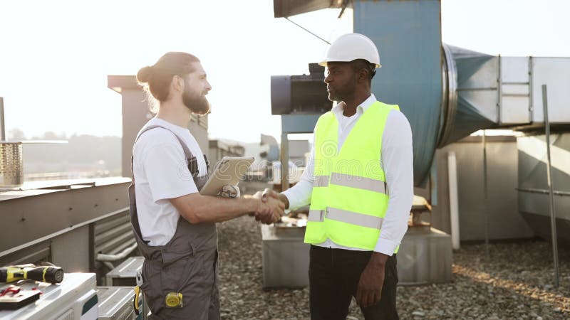Males Engineers Standing and Shaking Hands on Roof Stock Footage ...